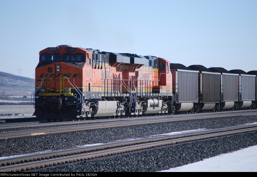 BNSF 6306 and BNSF 6197 push a loaded coal train east as rear DPU Units.